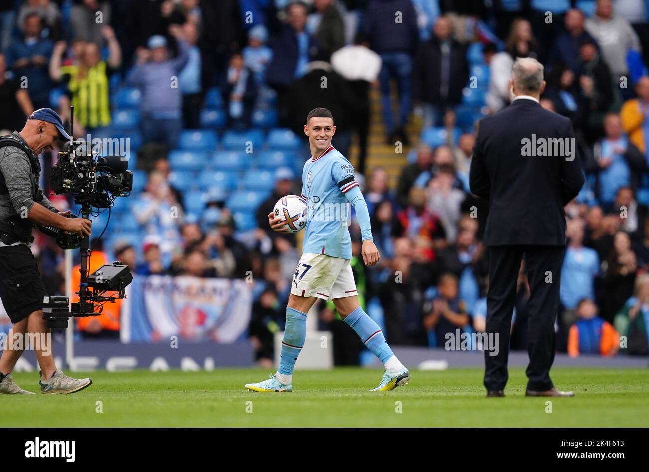 Manchester City's Phil Foden celebrates with the match ball following ...