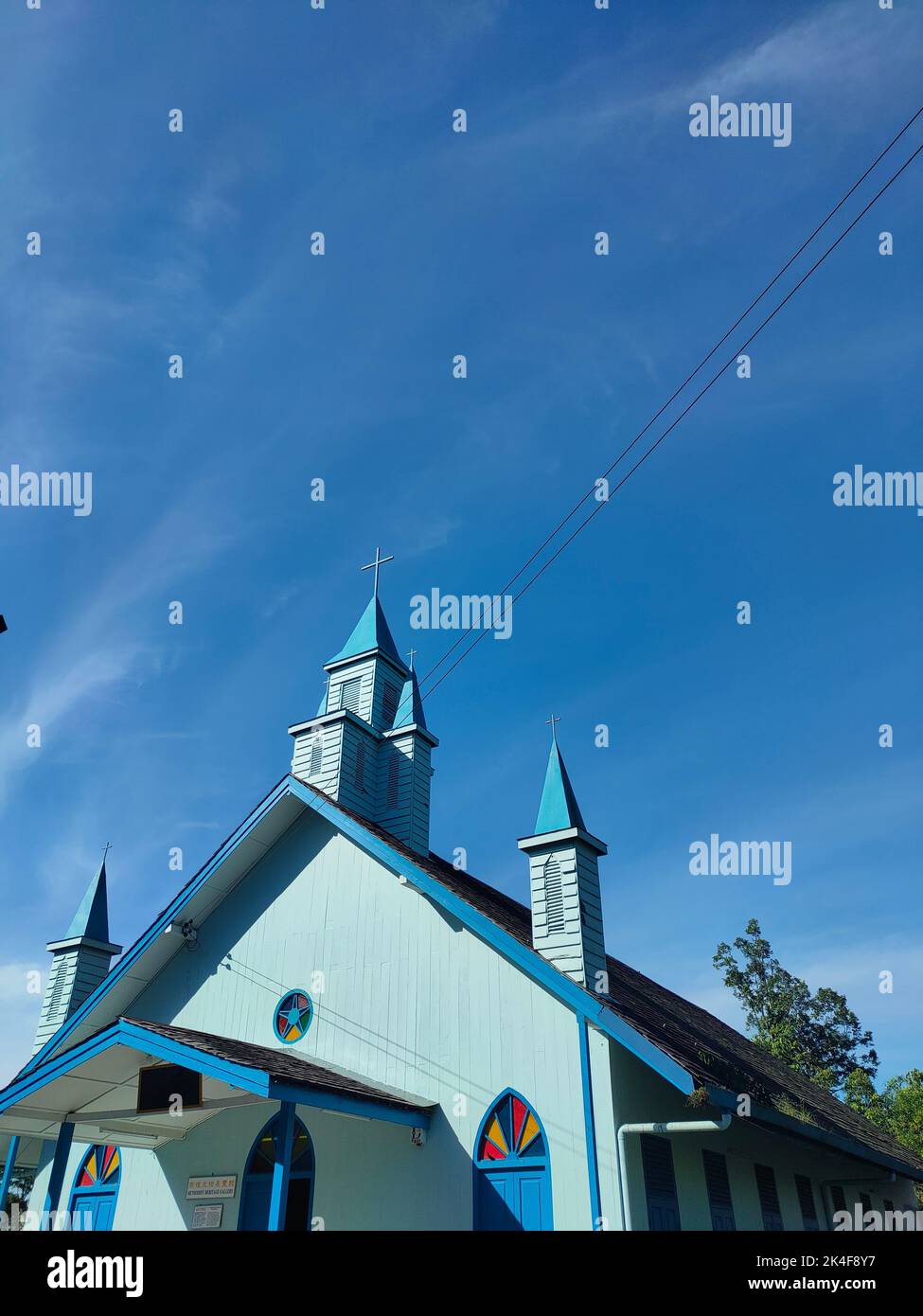 A vertical shot of a beautiful historic blue church in Bintulu ...