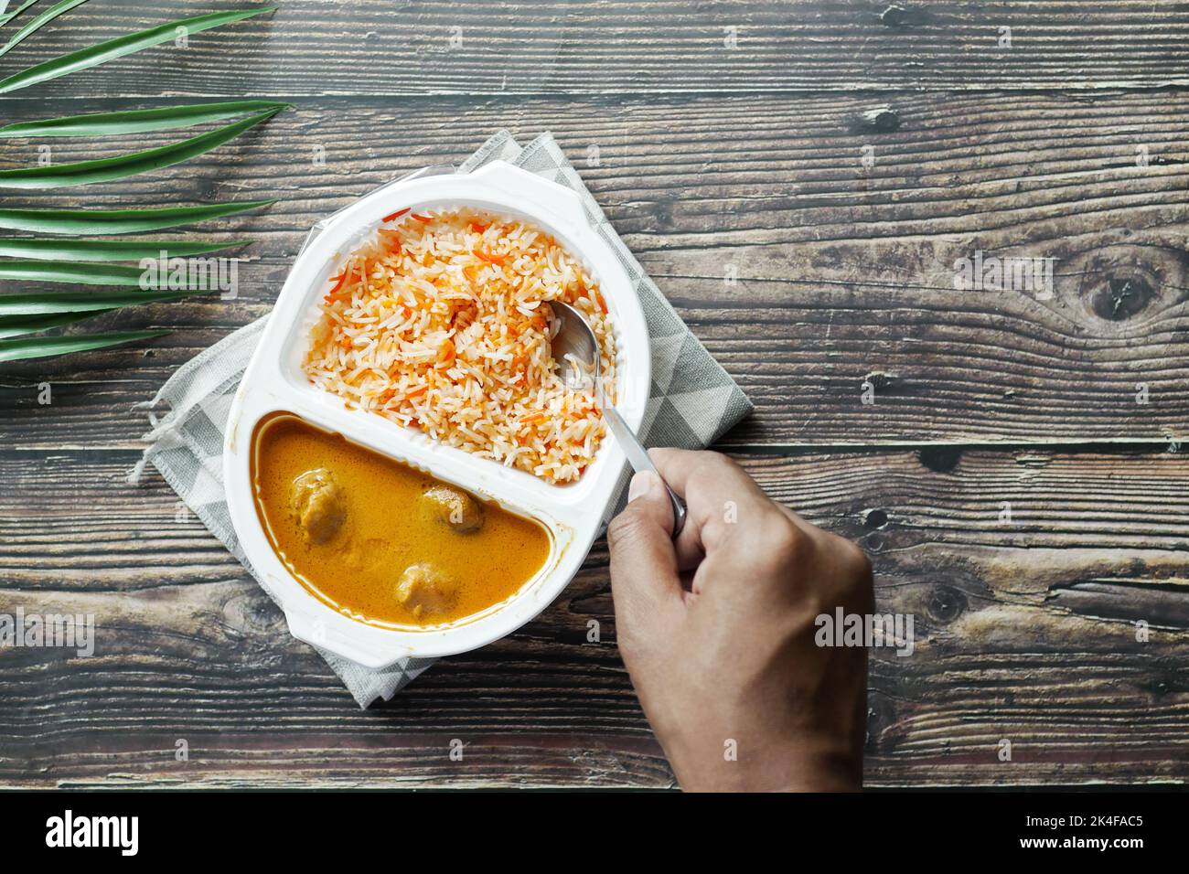curry chicken and rice in a take away plastic packet on table Stock ...