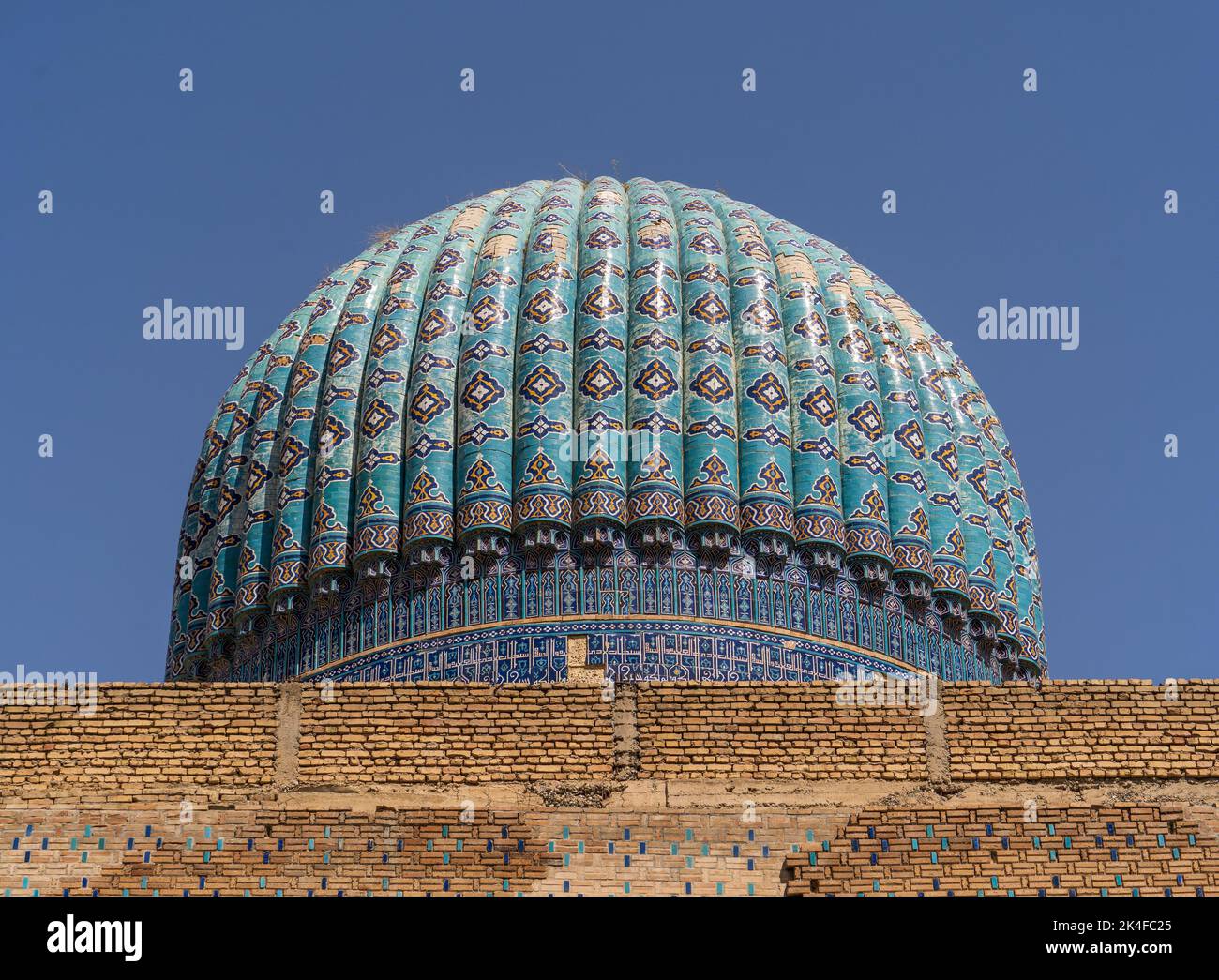 Zoom of Blue tile dome of Bibi-Khanym Mosque in bright blue sky in ...