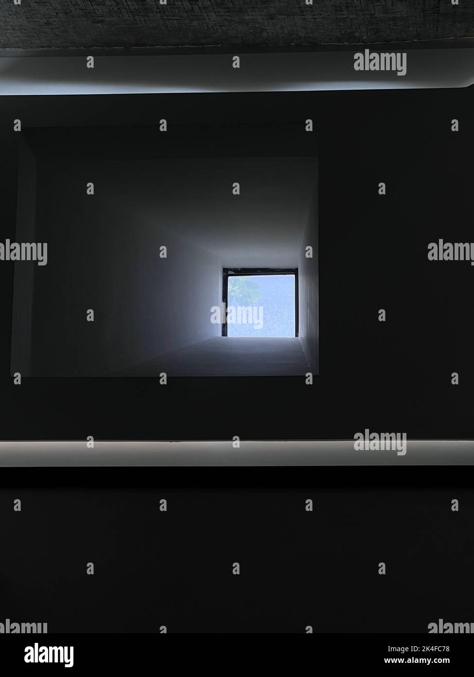 An empty dark room with a skylight shining through the window Stock ...