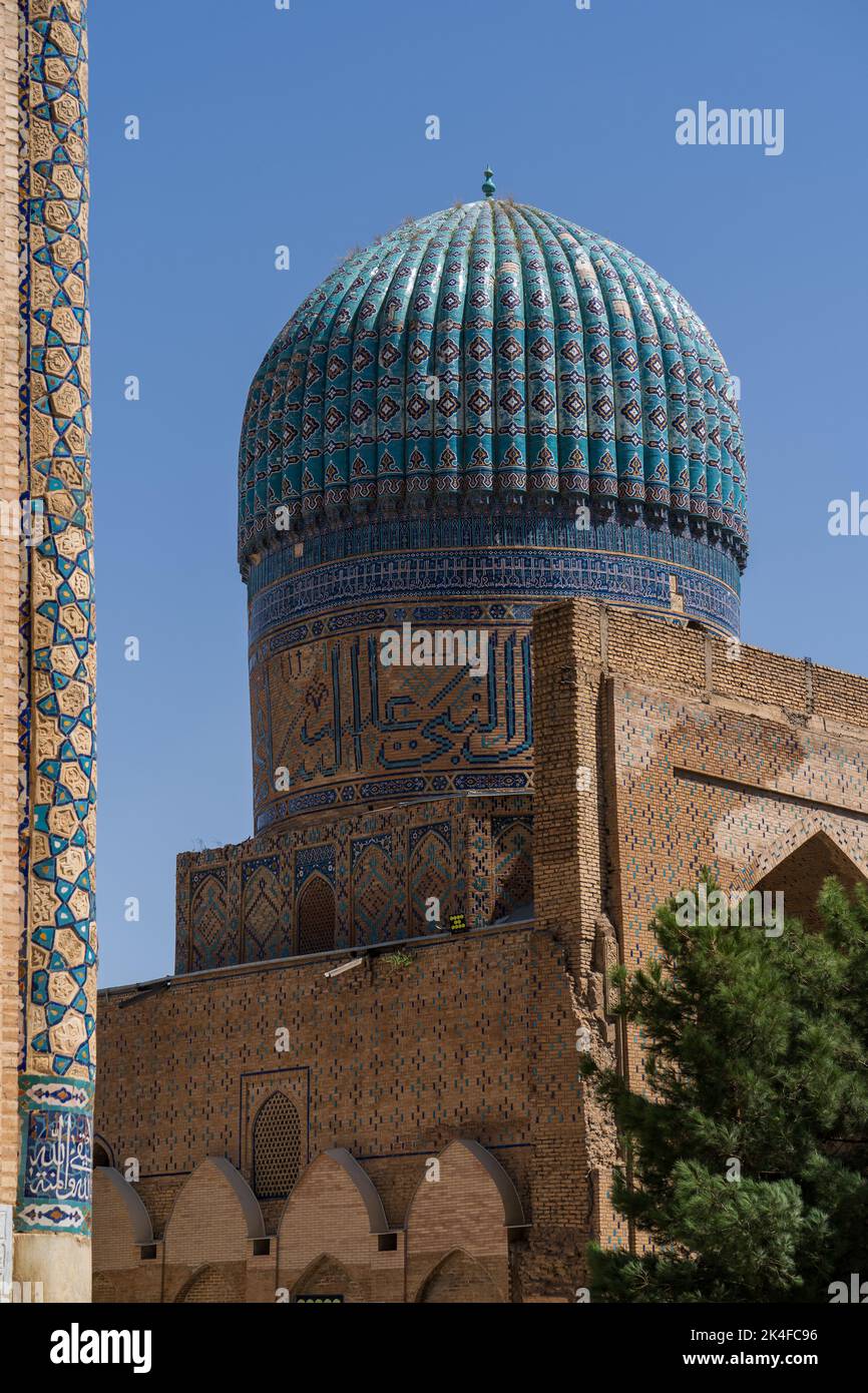 Blue tile dome and gate of Bibi-Khanym Mosque in bright blue sky in ...