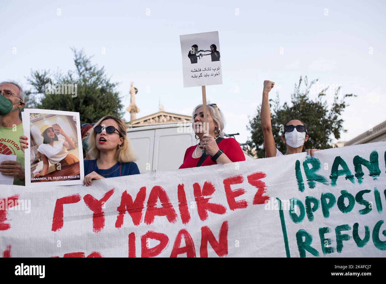 Protesters hold a banner expressing their opinions during the ...