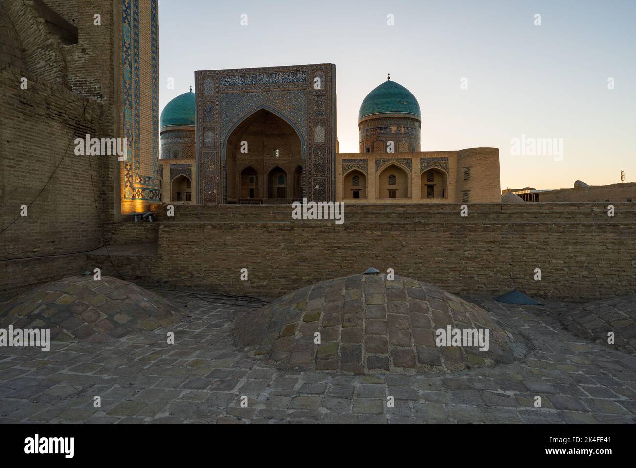 Sunrise view of roof-top vaults of Kalan Mosque and Mir-i-Arab Madrasa, Kalon Minaret Tower ...