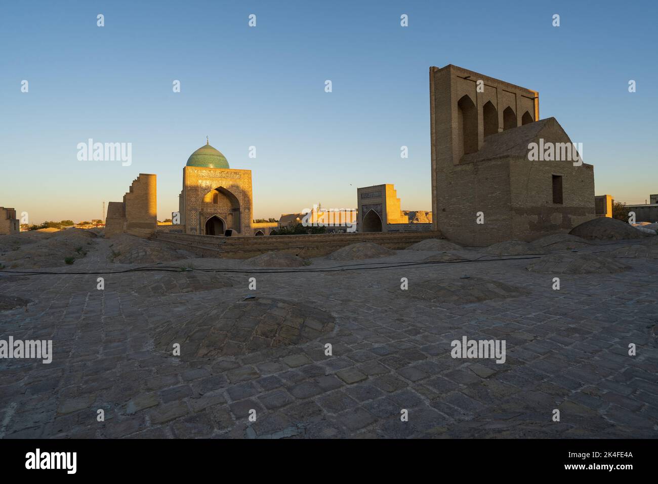 Sunrise view of roof-top vaults of Kalan Mosque and Mir-i-Arab Madrasa, Kalon Minaret Tower ...