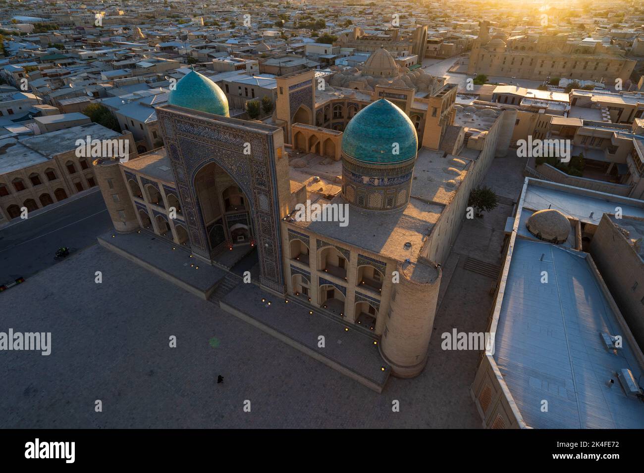 Sunrise view of roof-top vaults of Mir-i-Arab Madrasa from Kalon Minaret Tower, Bukhara Stock ...