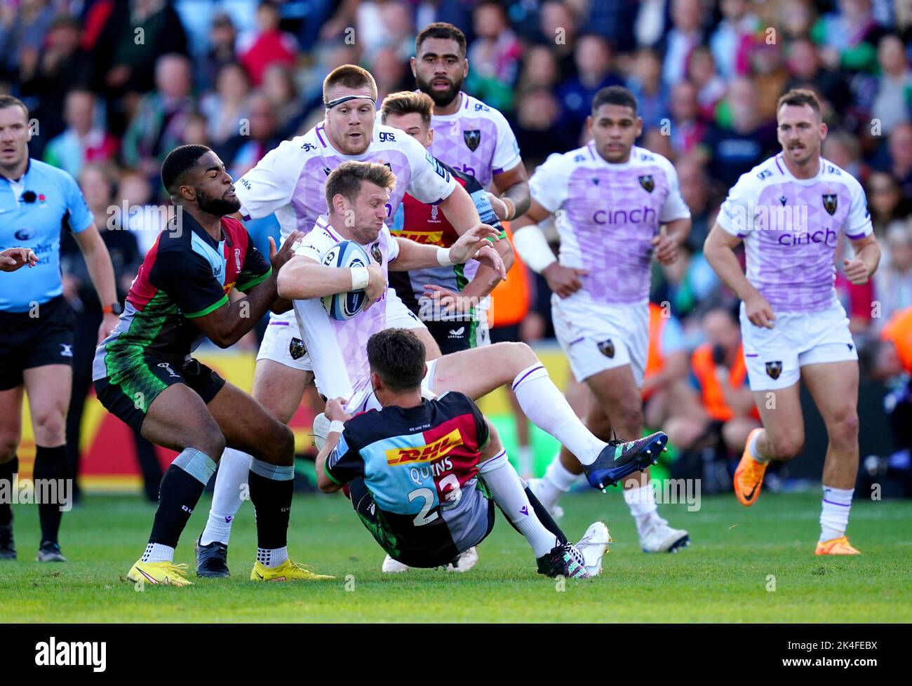 Northampton Saints' Dan Biggar is tackled by Harlequins' Nick David ...