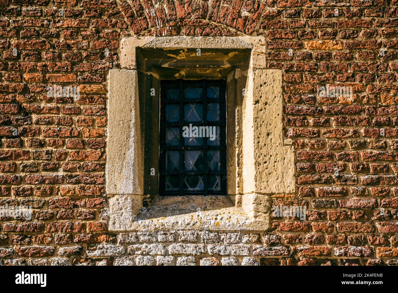 Stain Glass Window against a brick wall Stock Photo - Alamy