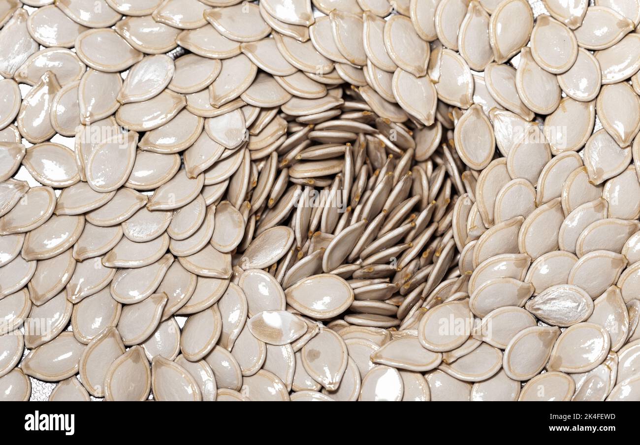 Pumpkin seeds creating a natural, spiral structure. Pure pumpkin seeds ...