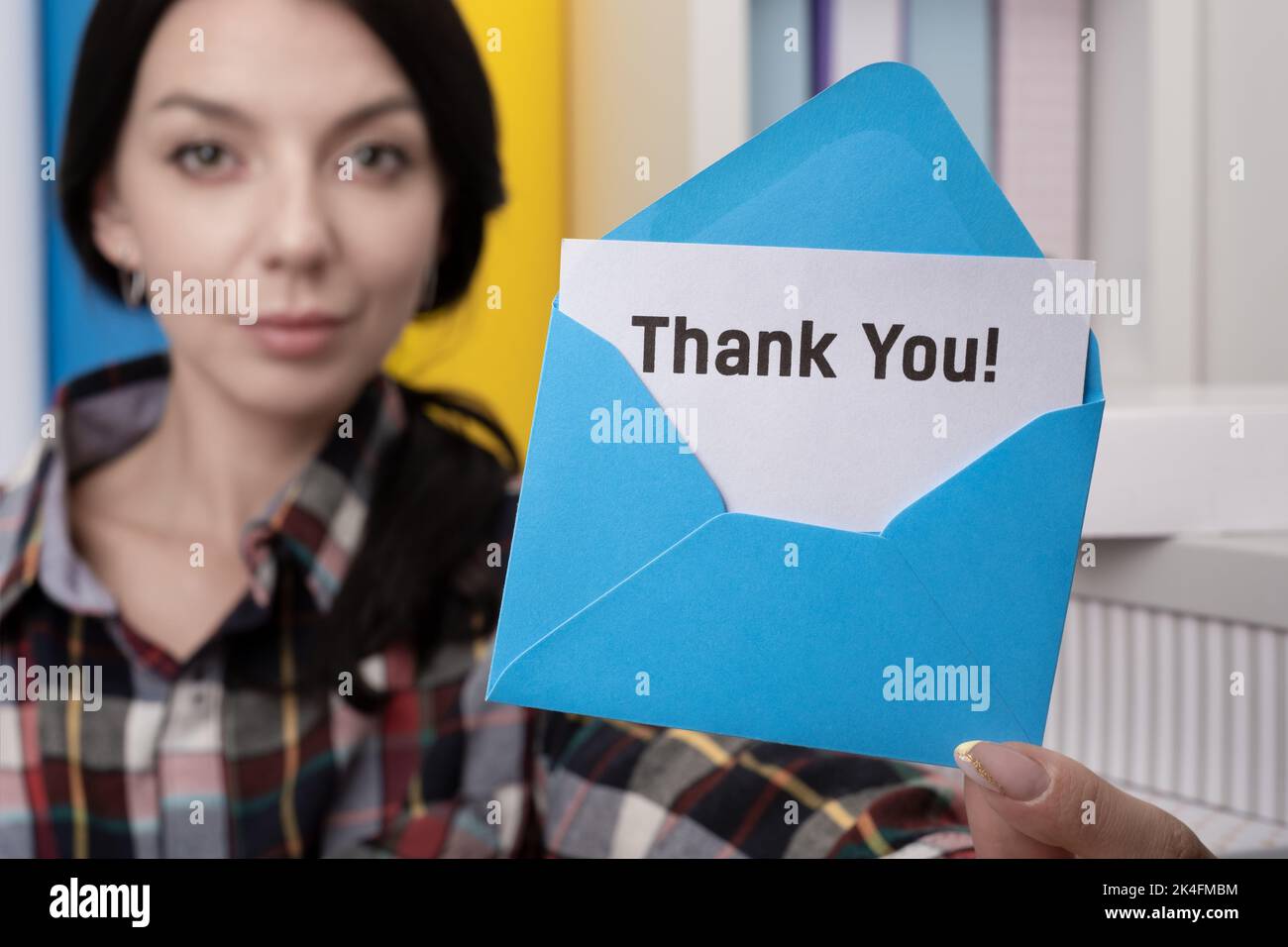 Woman showing Thank You note card in envelope. Act of kindness Stock ...