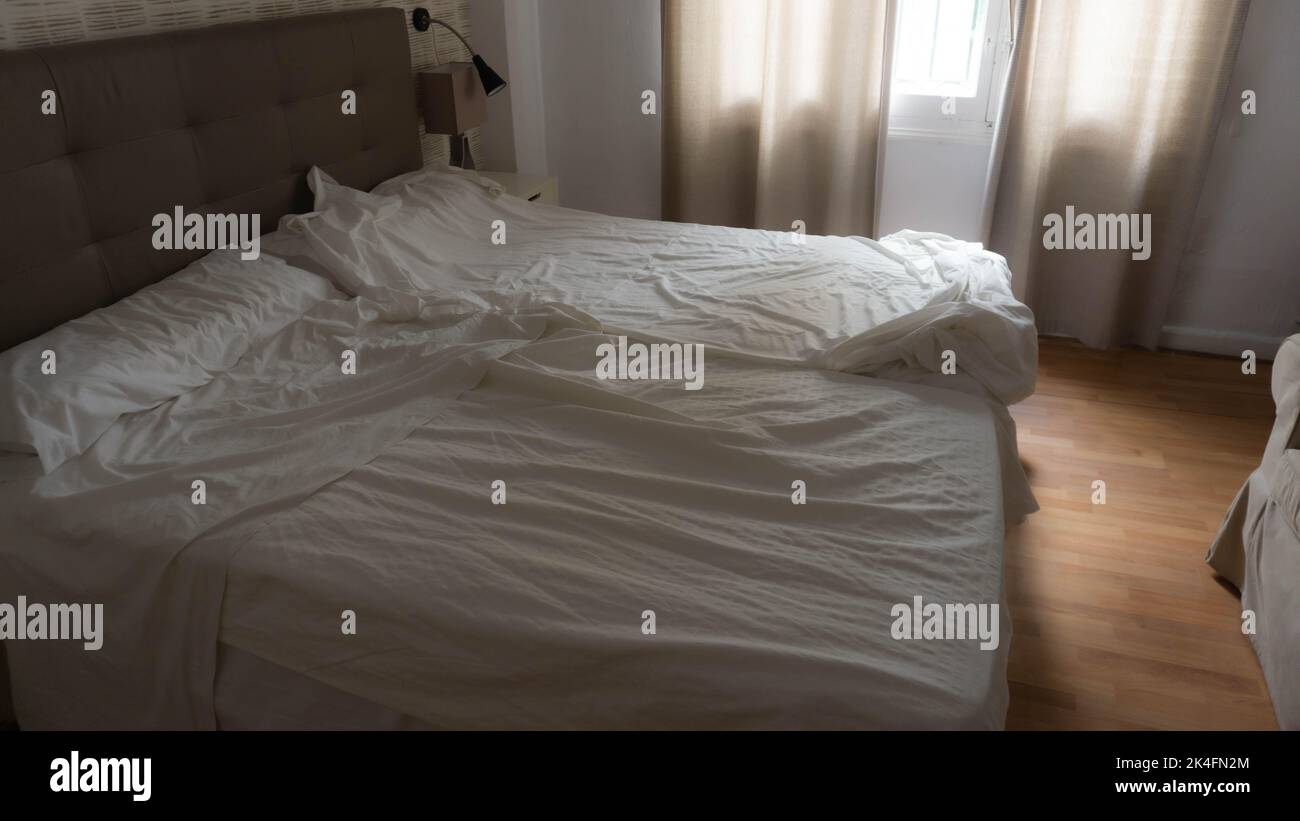bedroom with bed unmade Stock Photo - Alamy