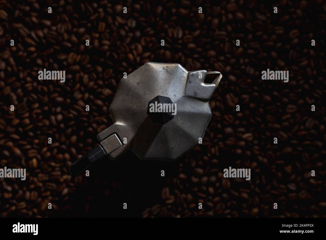 Italian geyser coffee maker on a background of coffee beans Stock Photo ...