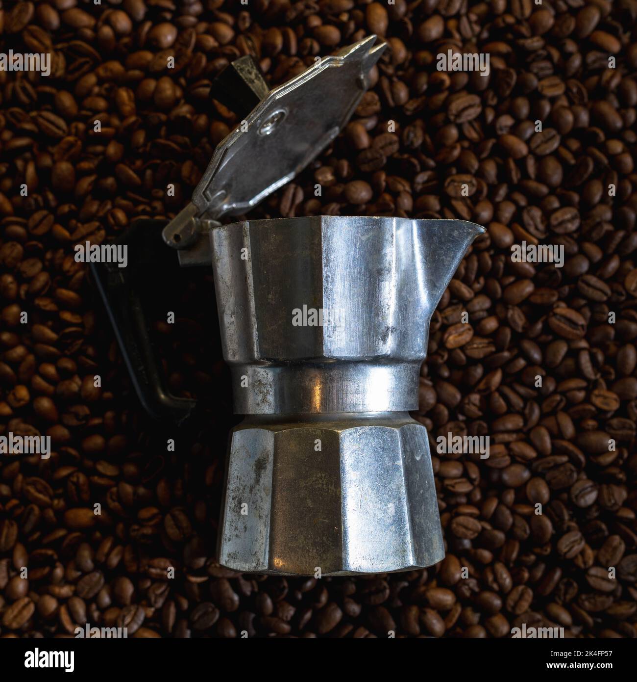 Italian geyser coffee maker on a background of coffee beans Stock Photo ...