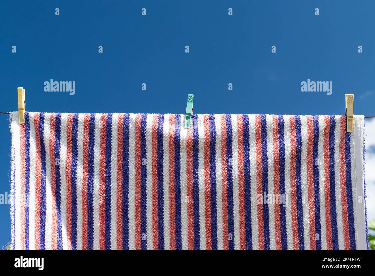 Clothes peg on a towel and washing line against a blue sky Stock Photo ...