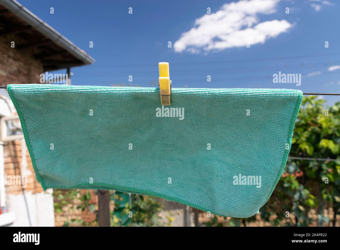 Clothes peg on a towel and washing line against a blue sky Stock Photo ...