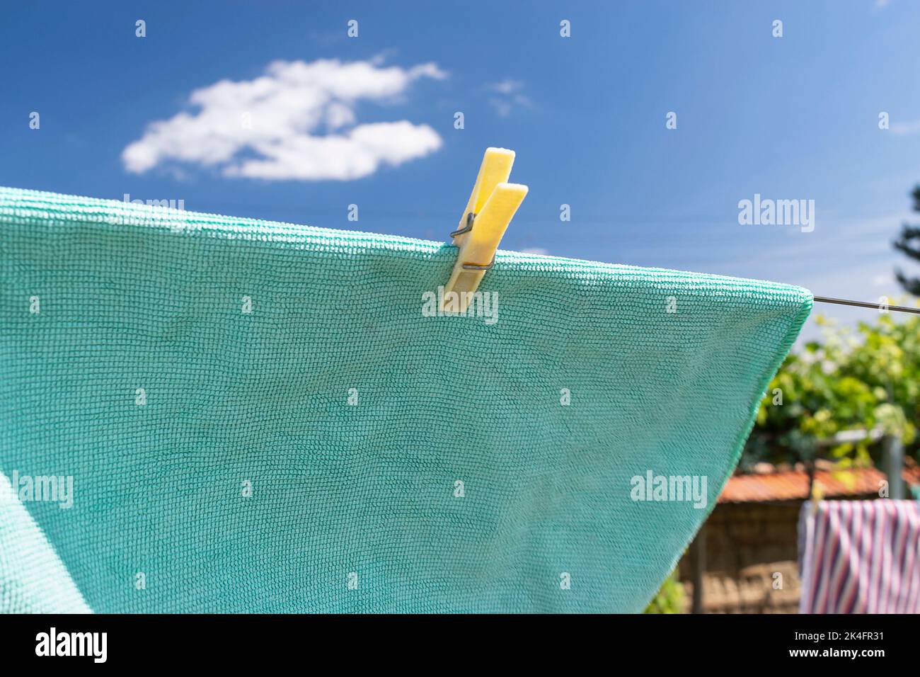 Clothes peg on a towel and washing line against a blue sky Stock Photo ...