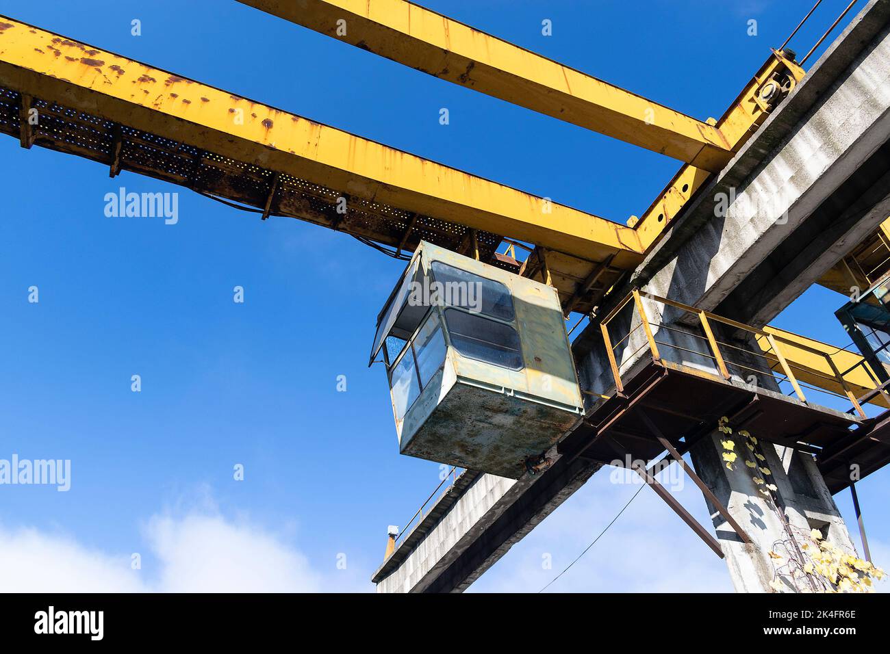Big yellow lifting crane in the factory Stock Photo - Alamy