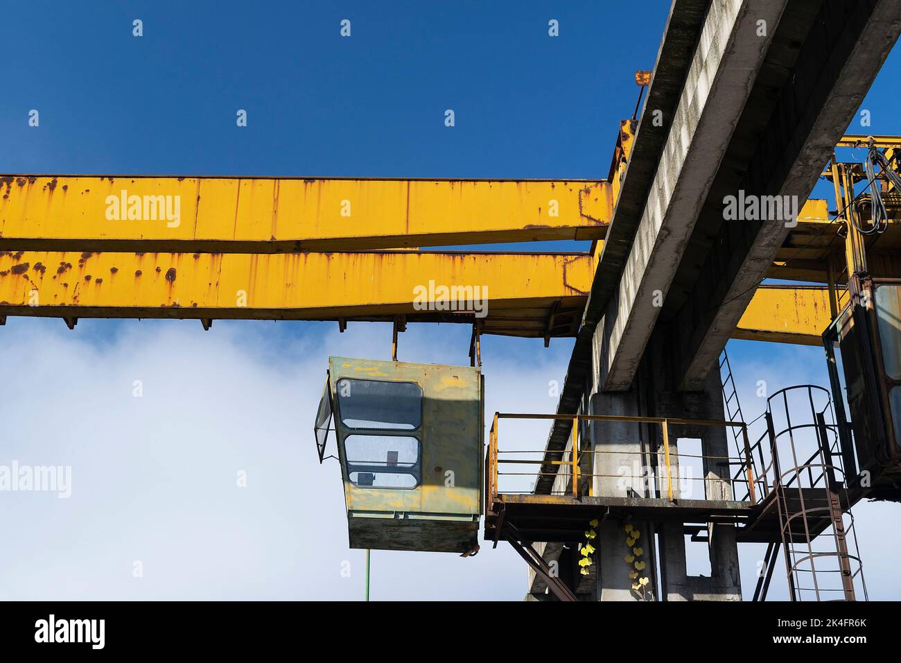 Big yellow lifting crane in the factory Stock Photo - Alamy