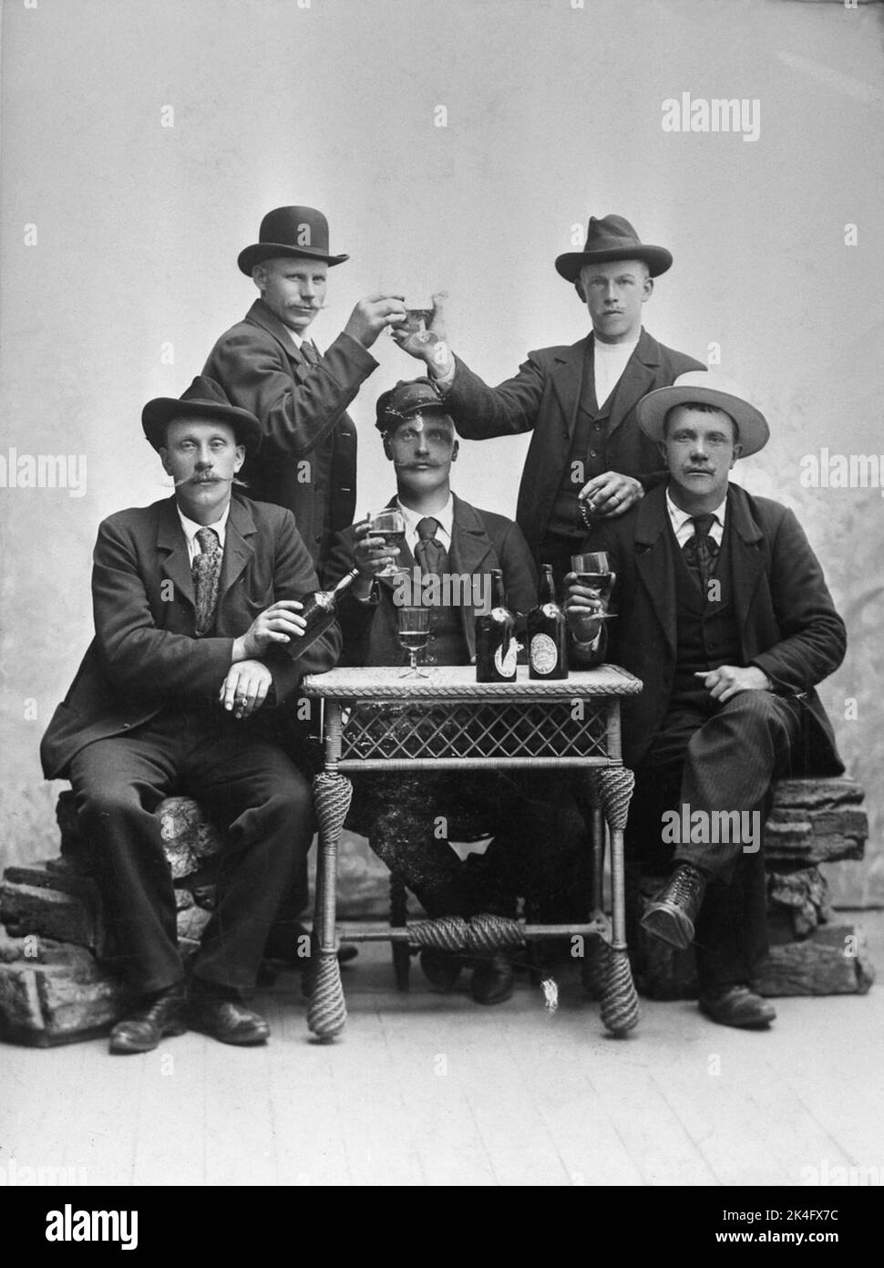 Group picture, studio image. Five men toast around a table. Nordic ...
