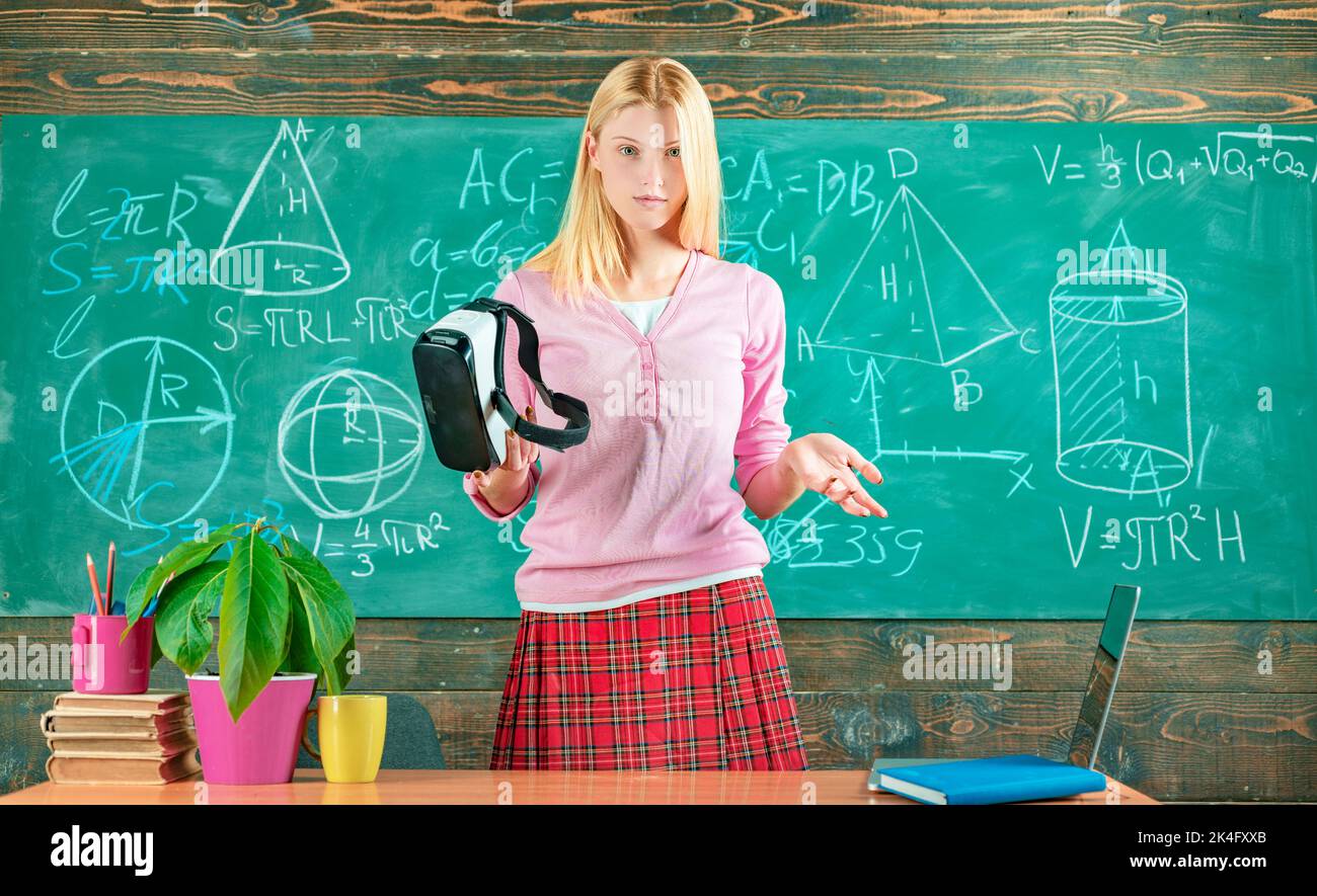 Young teen student with headset vr on blackboard in classroom ...