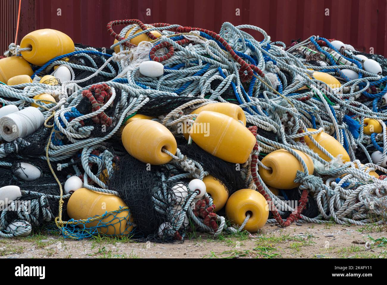industrial fishing nets with bright floats is folded ashore Stock Photo ...