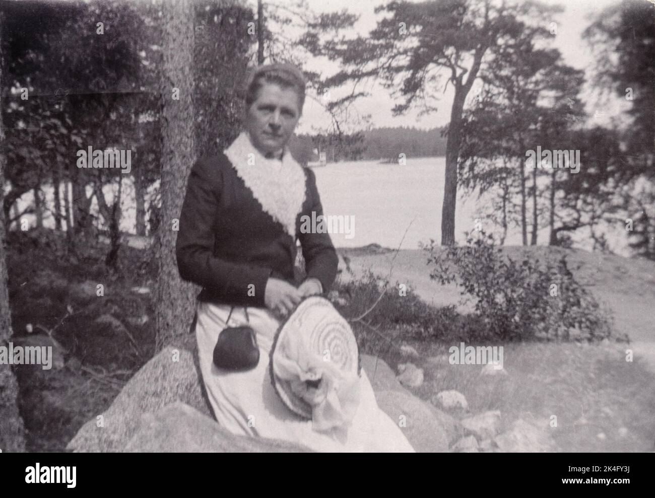 The awning Caroline Lagergren sits on stone in the forest with views of ...