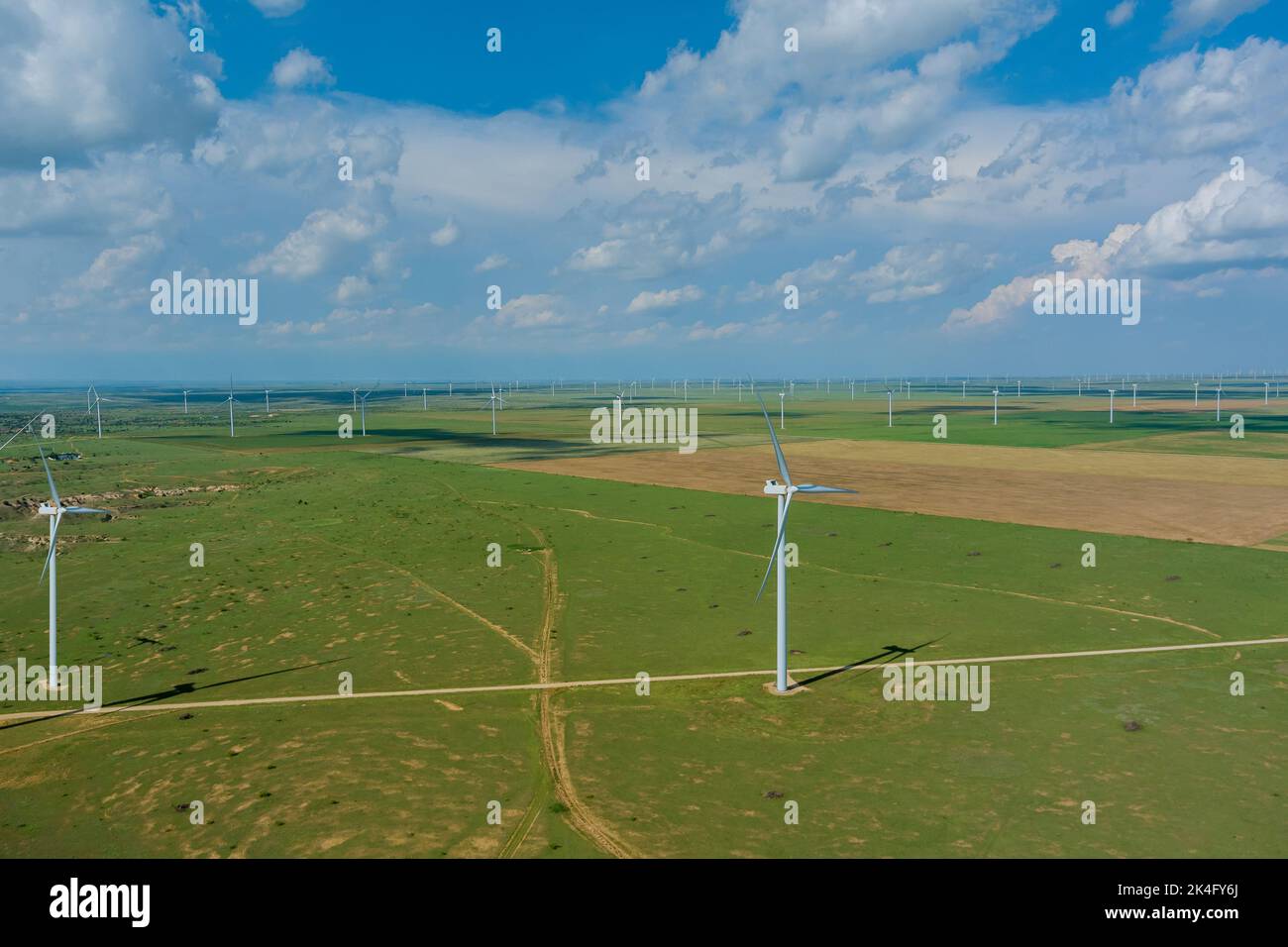 The wind farm in Texas USA has a row of wind turbines that are used for ...