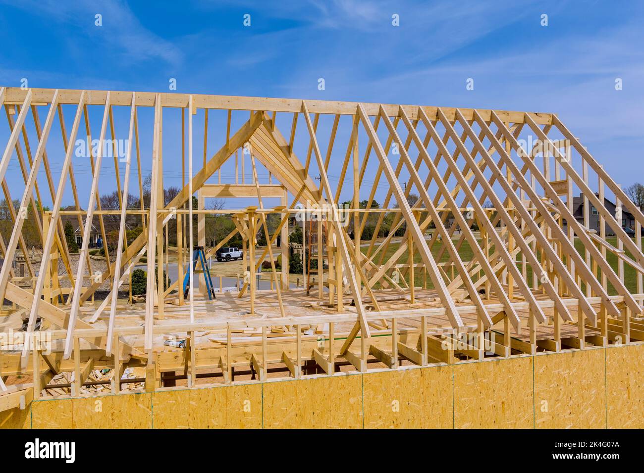 For the construction of a new house, a wooden truss roof beam is ...