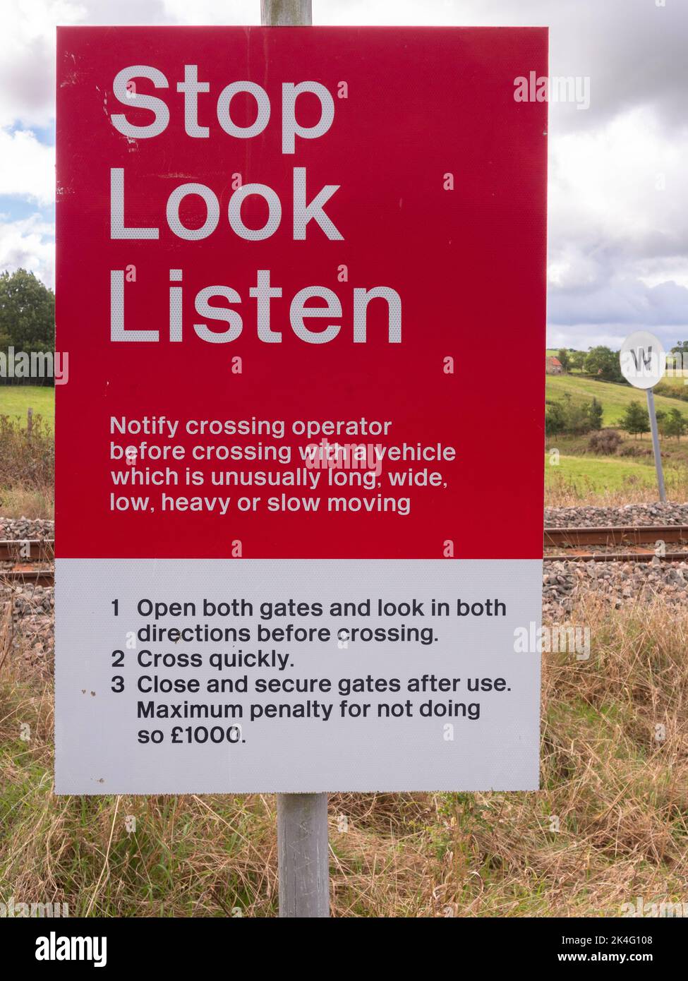 Unmanned level crossing sign Stop Look Listen on a rural branch line ...