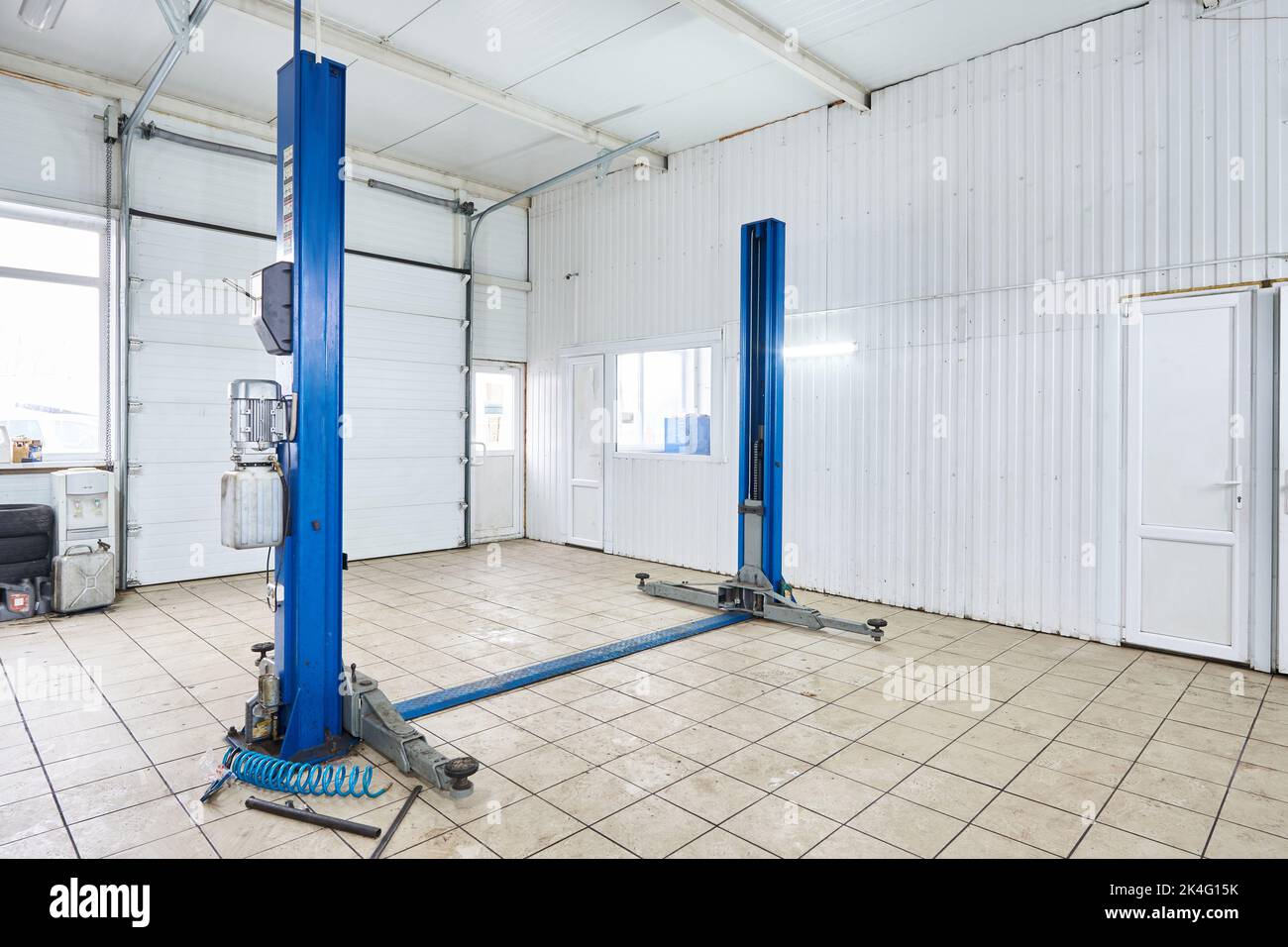 Blue car lift in car service station Stock Photo - Alamy