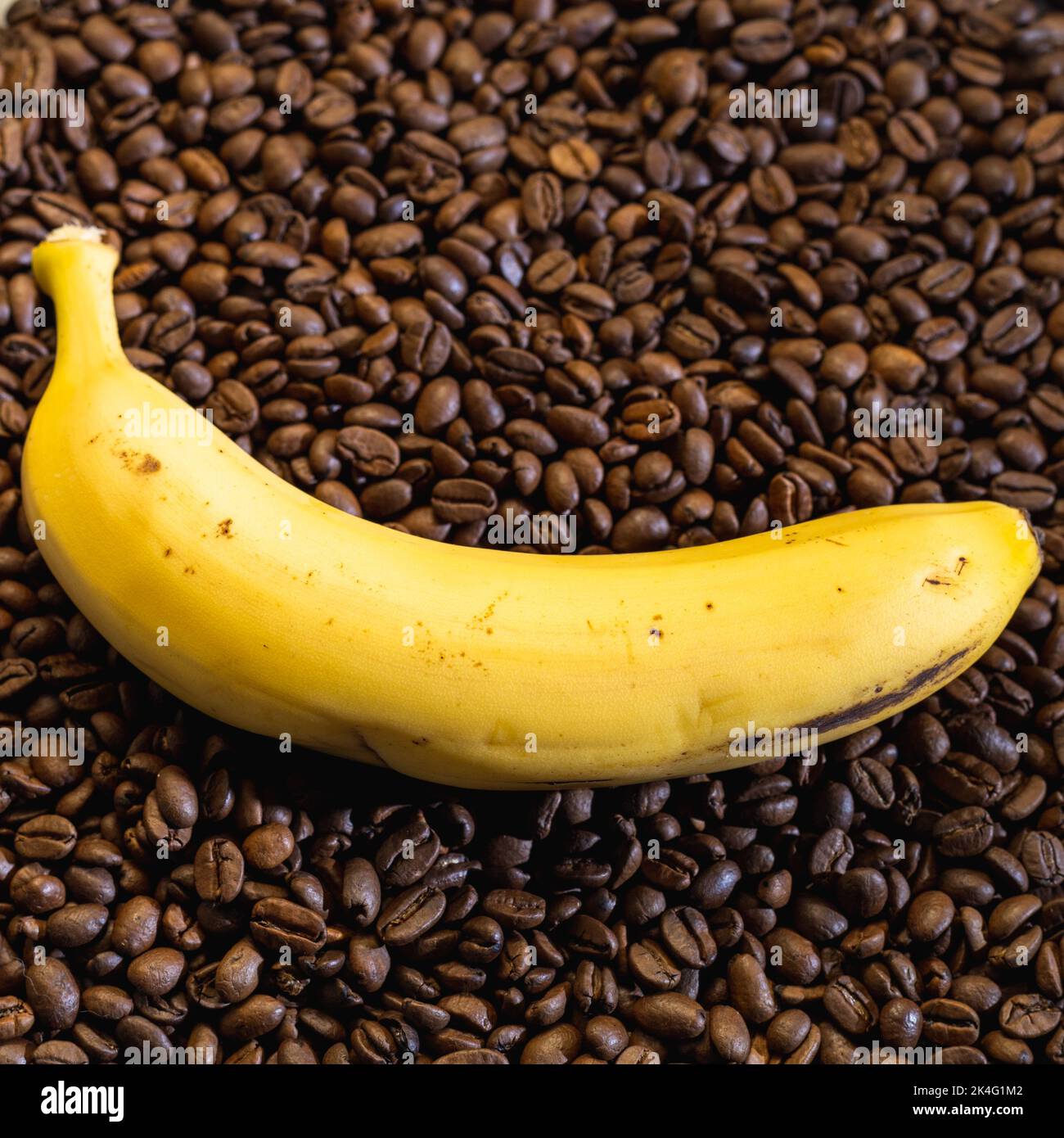 Banana on a background of coffee beans Stock Photo - Alamy