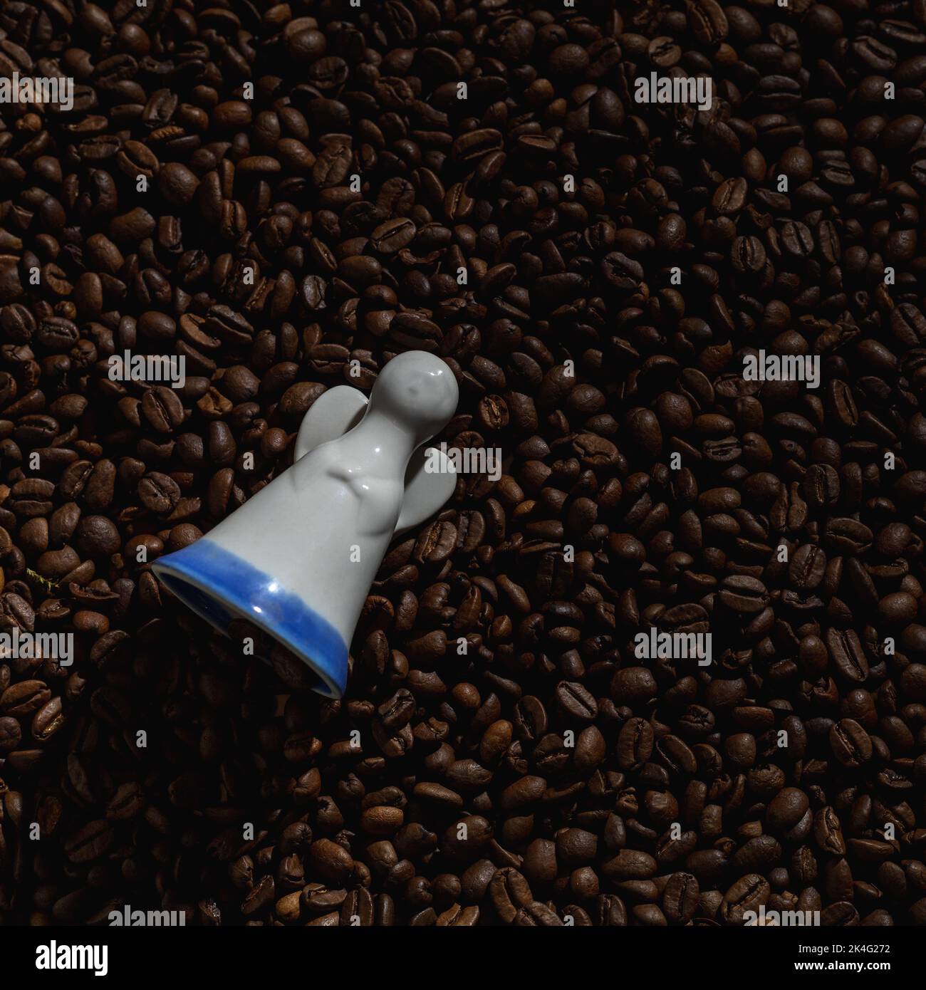 Figurine of an angel on a background of coffee beans Stock Photo - Alamy