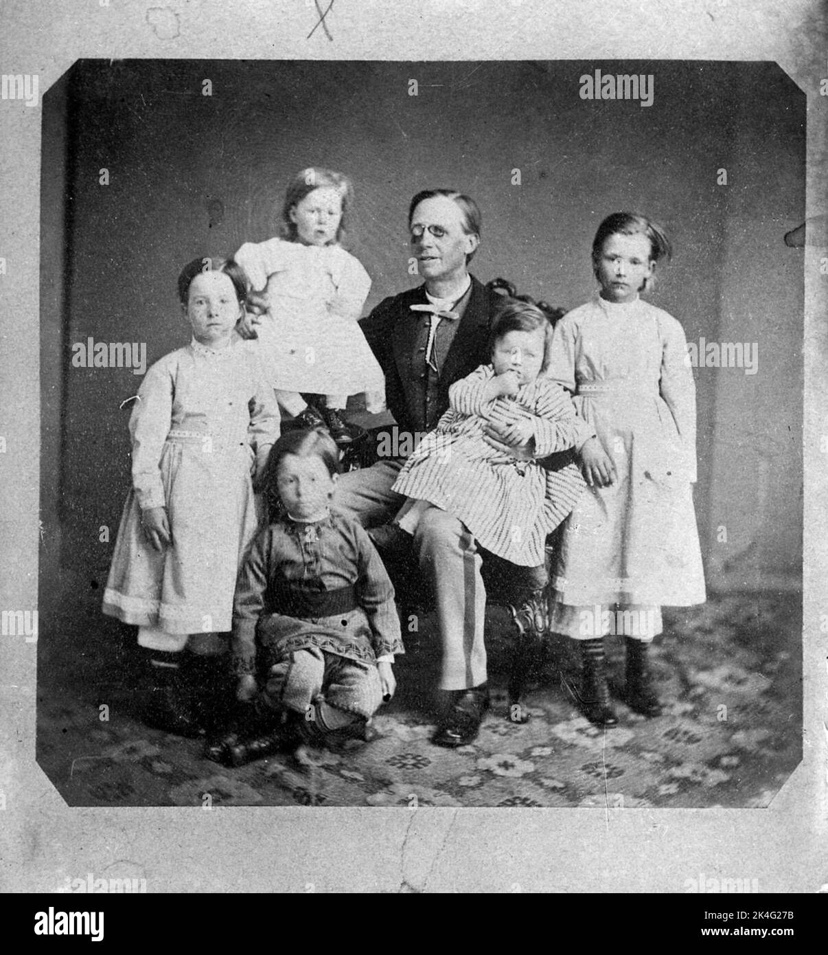 Reproduction of a group picture of a father with his five children ...
