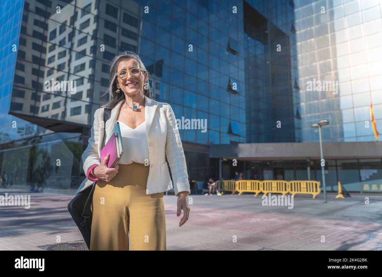 Confident, focused and powerful business woman walking in the street ...
