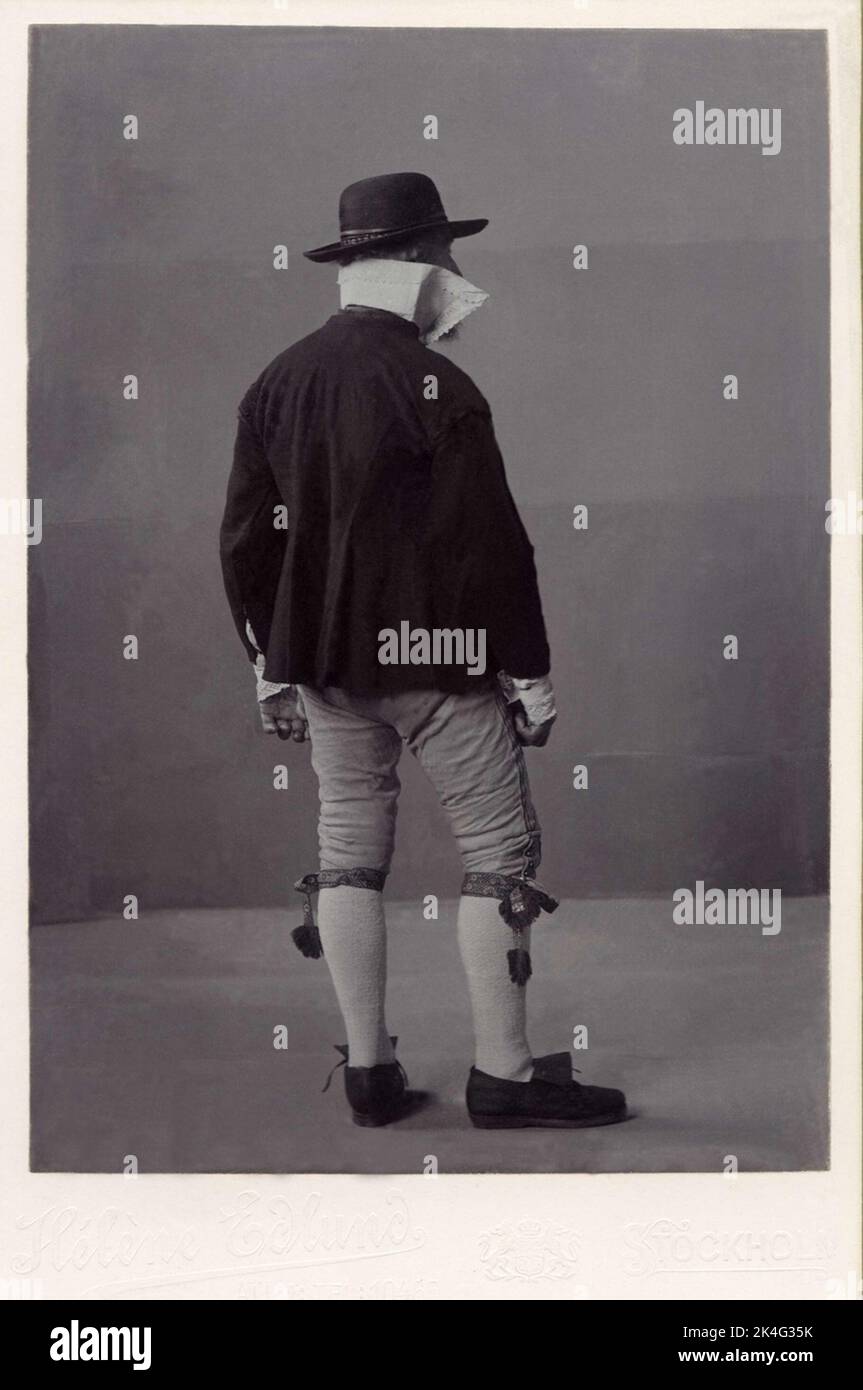 Bearded man dressed in folk costume with knee pants, jacket and hat ...