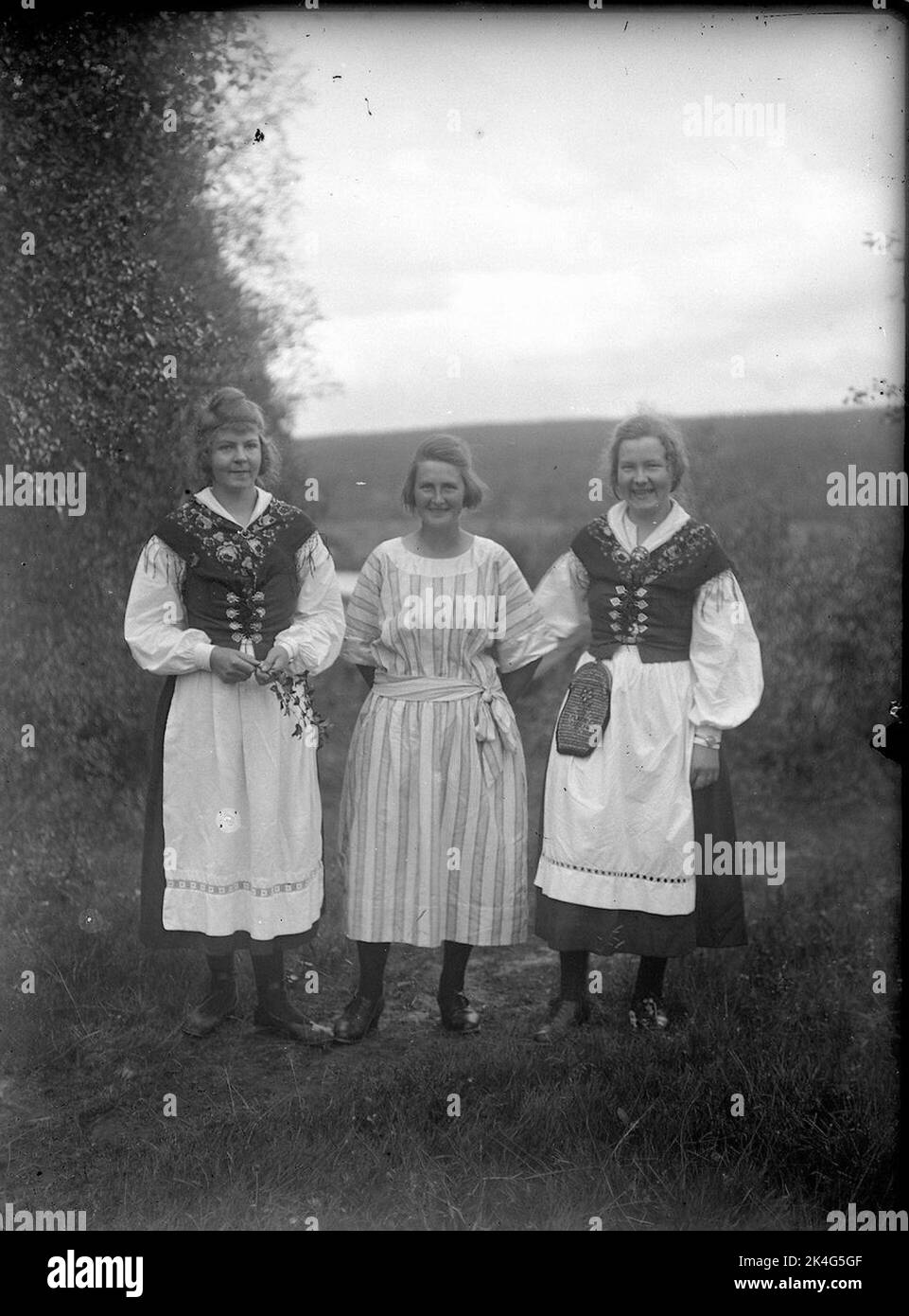 Portrait of three women in folk costumes in an outdoor environment ...