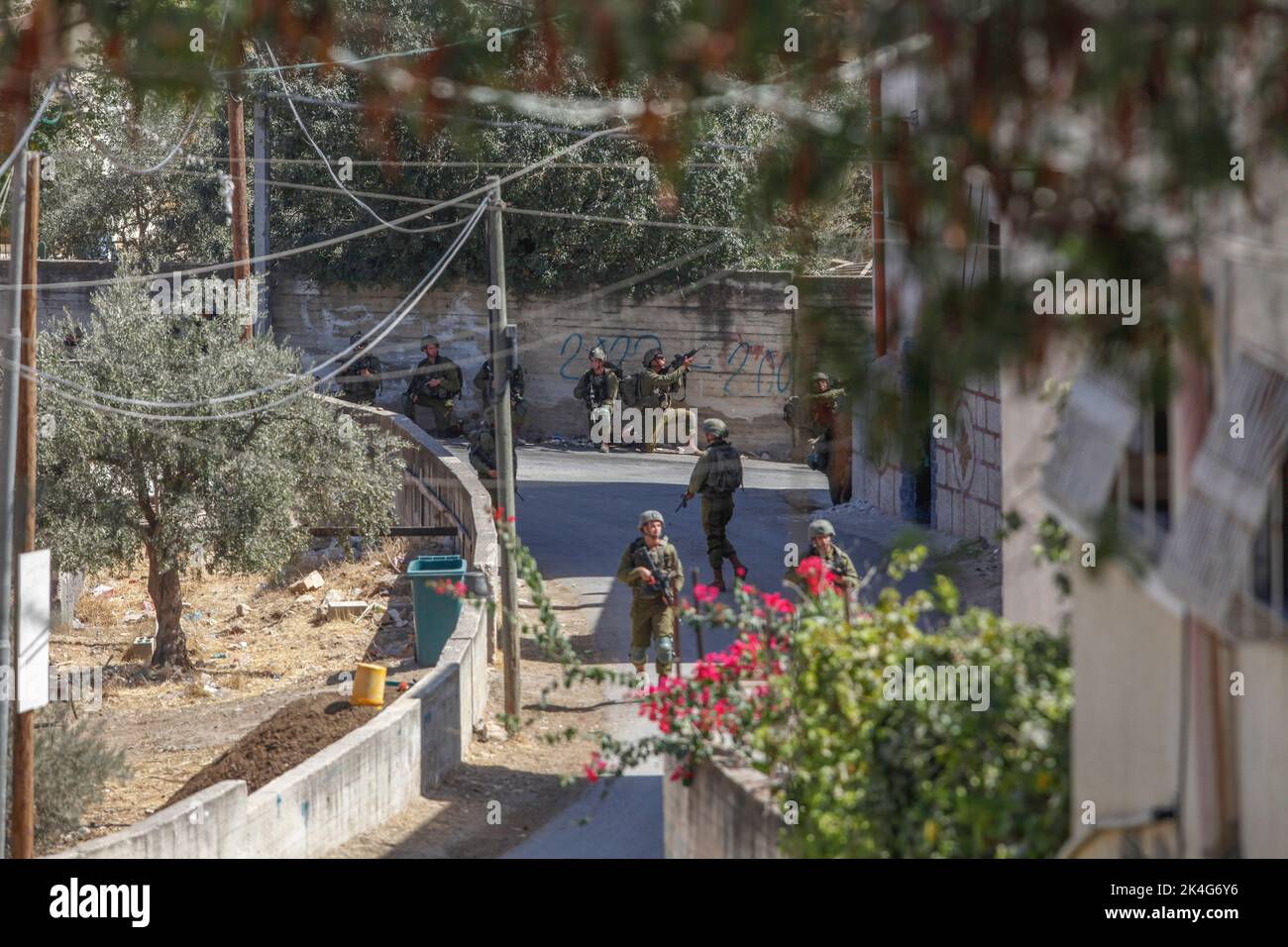 Nablus, Palestine. 02nd Oct, 2022. Israeli soldiers patrol during a ...