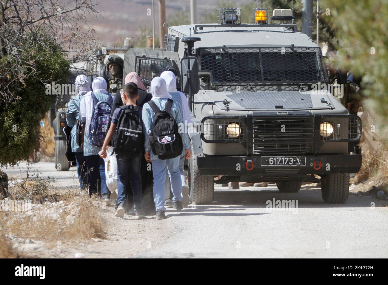 Nablus, Palestine. 02nd Oct, 2022. Palestinian students pass next to a ...