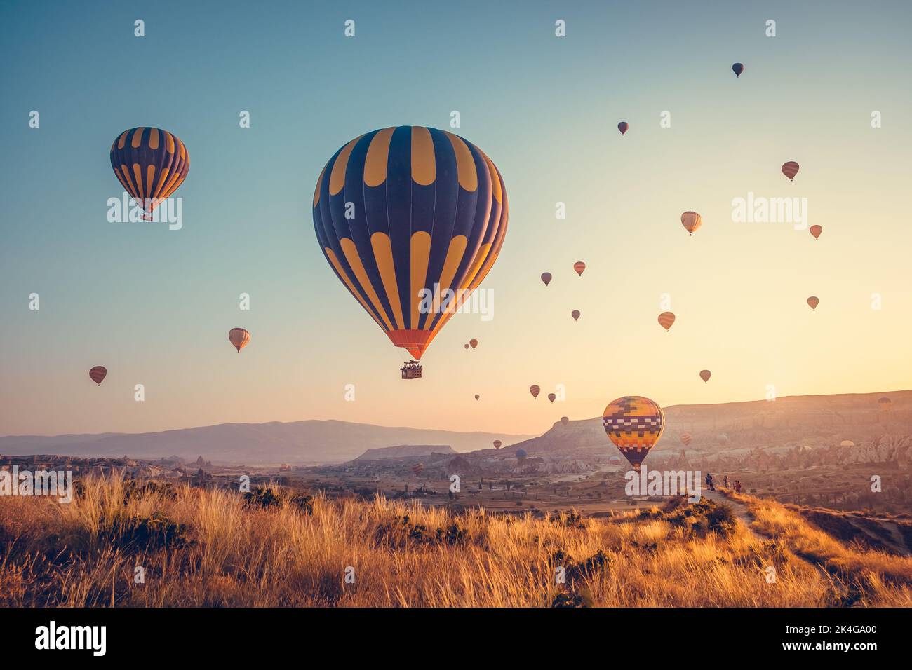Amazing sunrise with colorful hot air balloons over spectacular ...