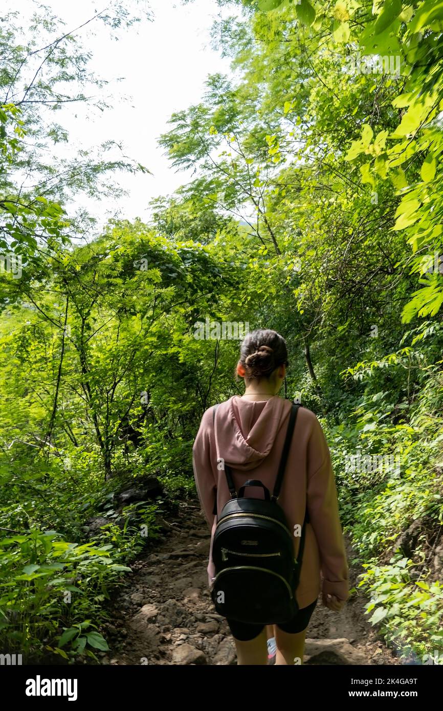 young woman descending in the ravine, vegetation and trees, huentitan ...