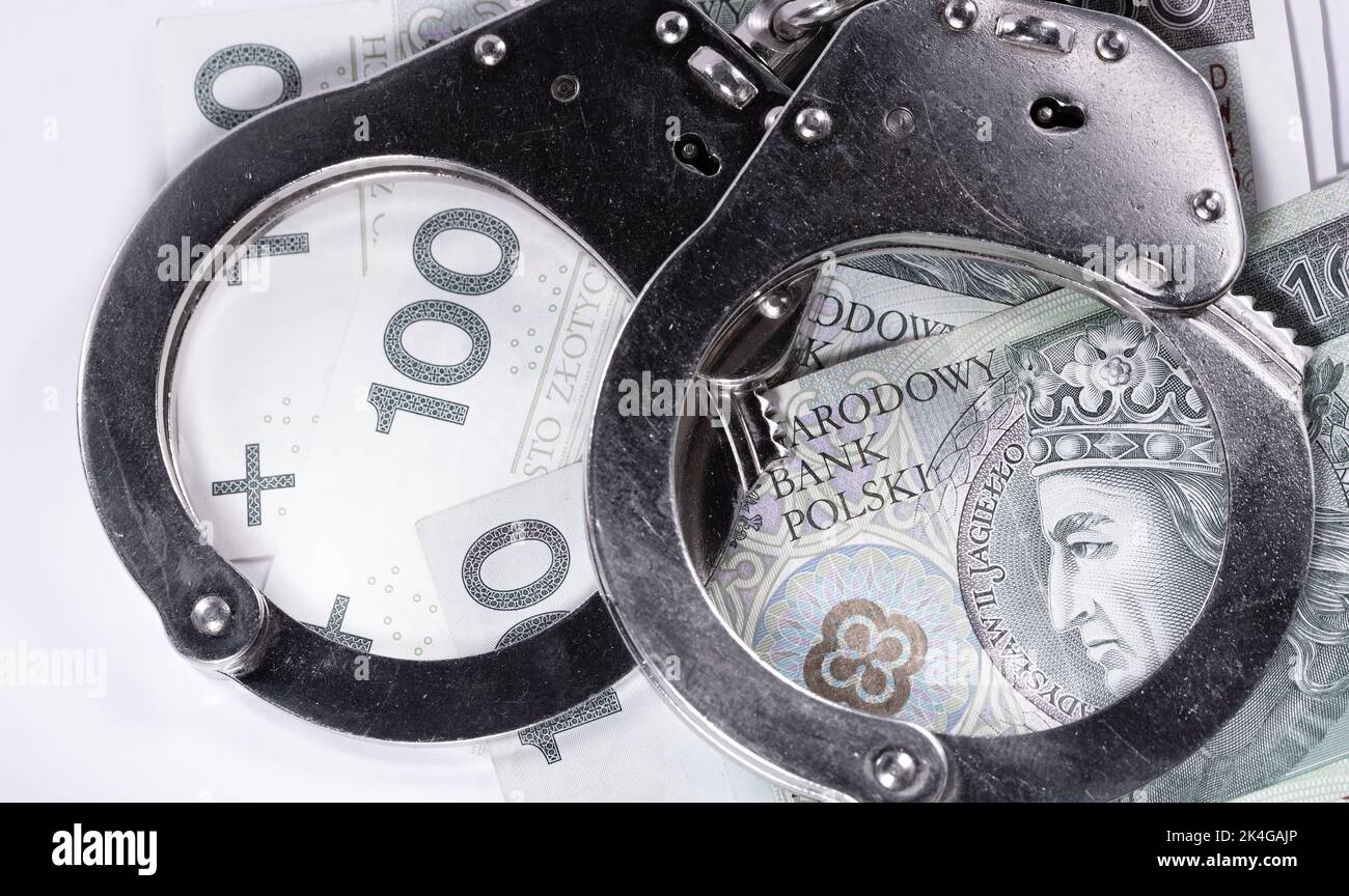 Police handcuffs and banknotes in Polish currency. The concept of ...