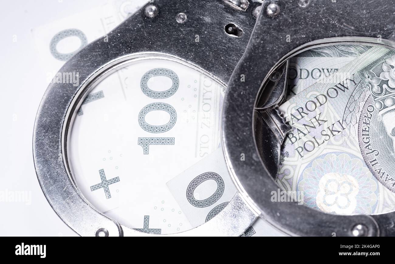 Police handcuffs and banknotes in Polish currency. The concept of ...