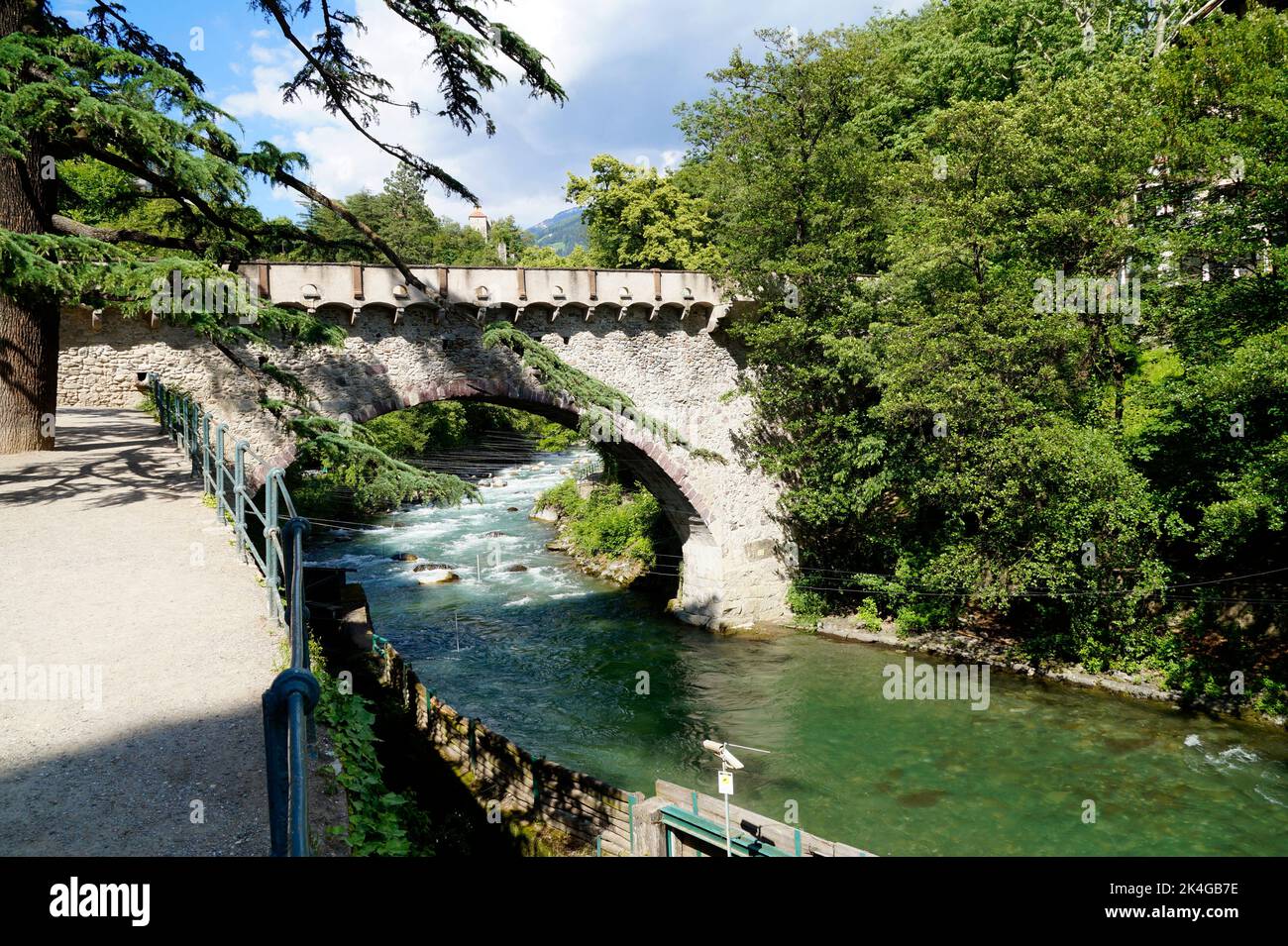 the picturesque mediterranean town of Merano with ornate stone bridge ...