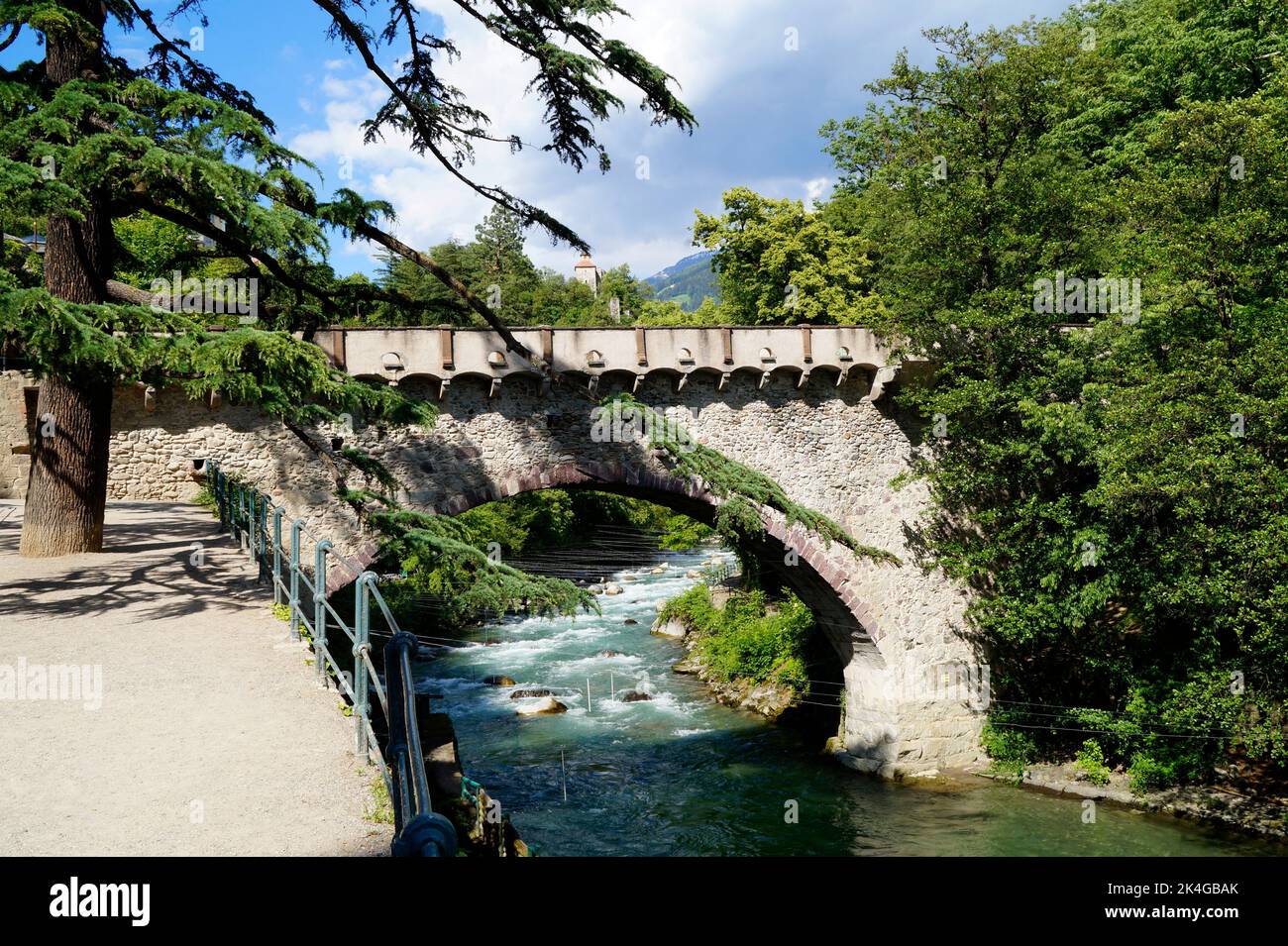 the picturesque mediterranean town of Merano with ornate stone bridge ...
