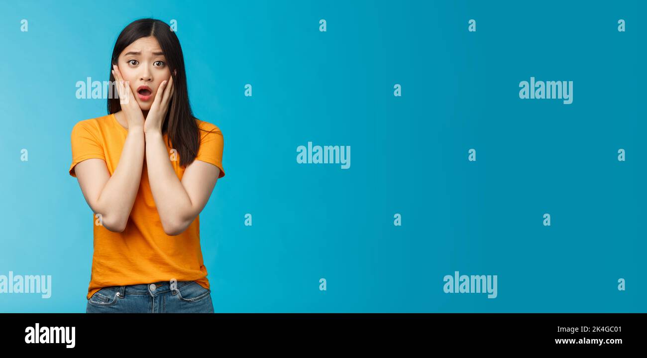 Shocked concerned young asian girl look empathy camera, gasping open ...