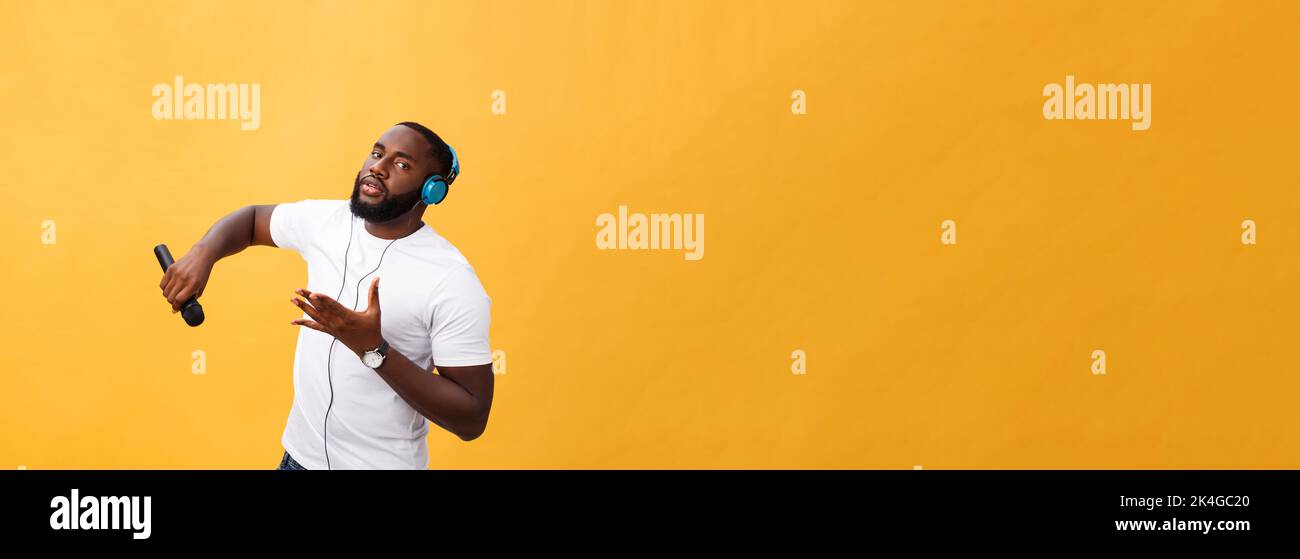 Portrait of cheerful positive chic handsome african man holding ...
