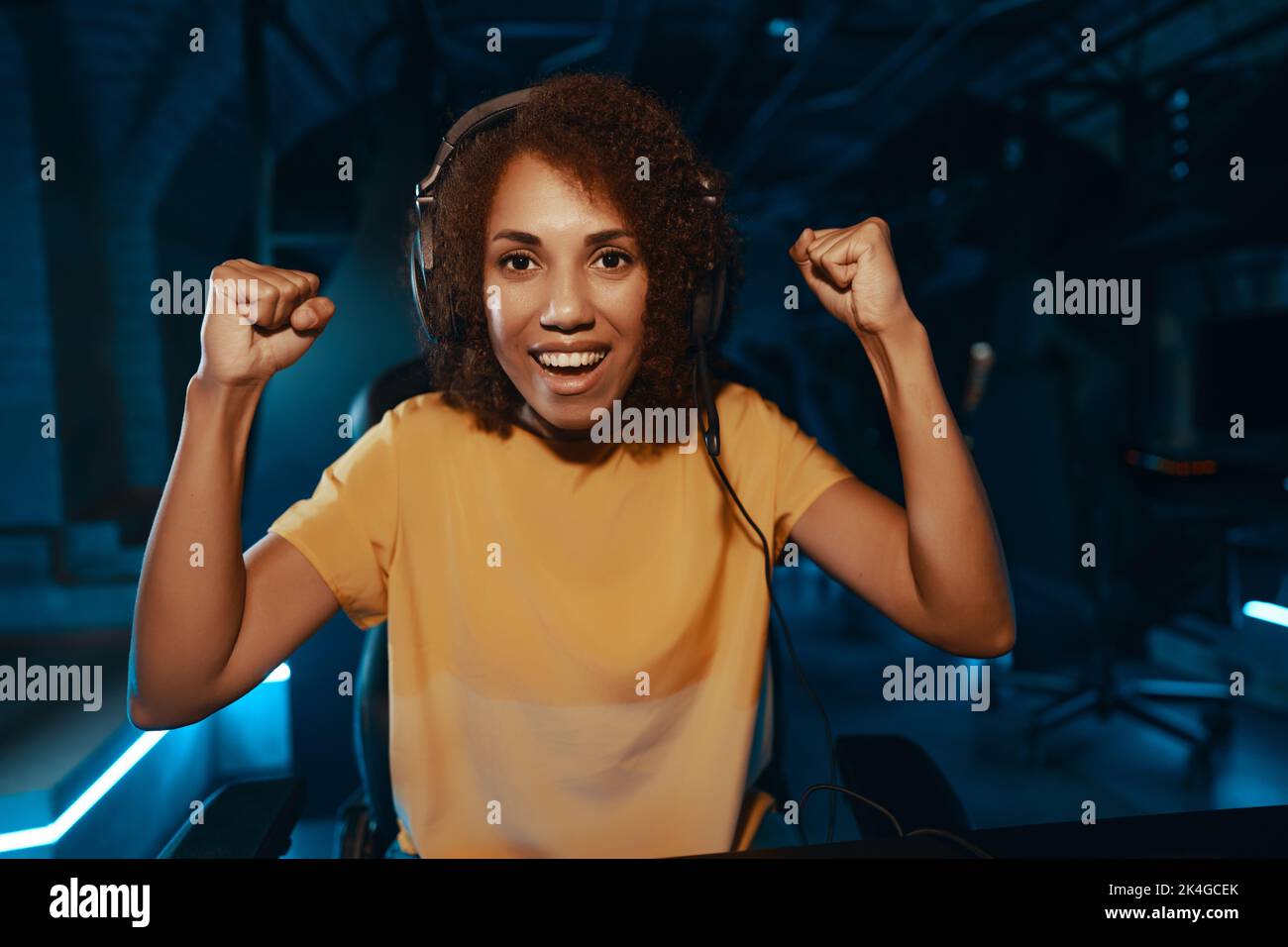Young curly woman playing cyber games Stock Photo - Alamy