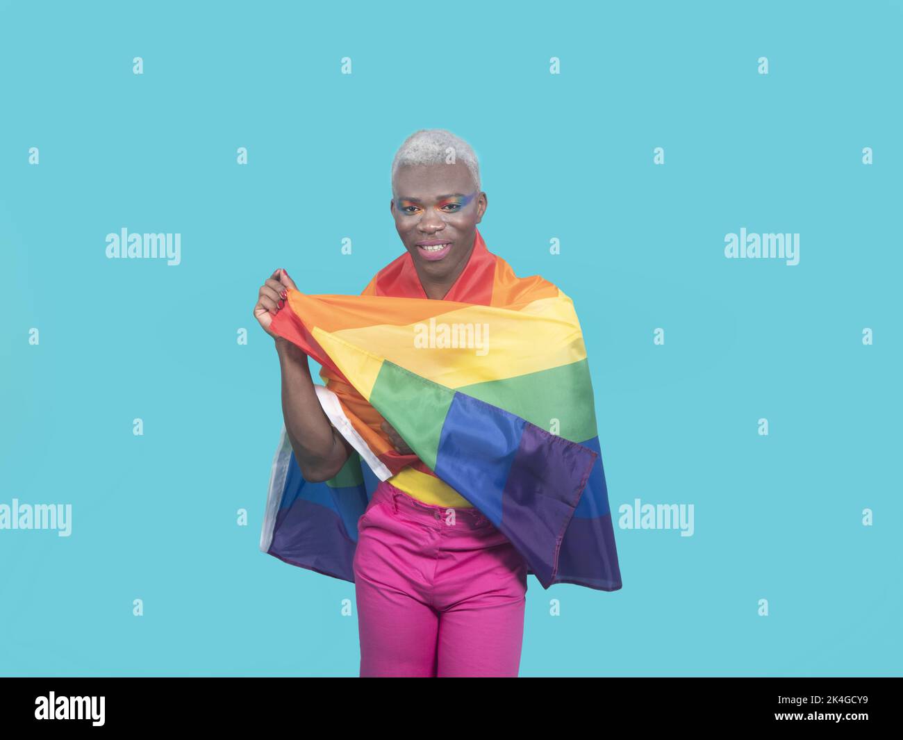 Positive African American male model with makeup looking at camera with ...