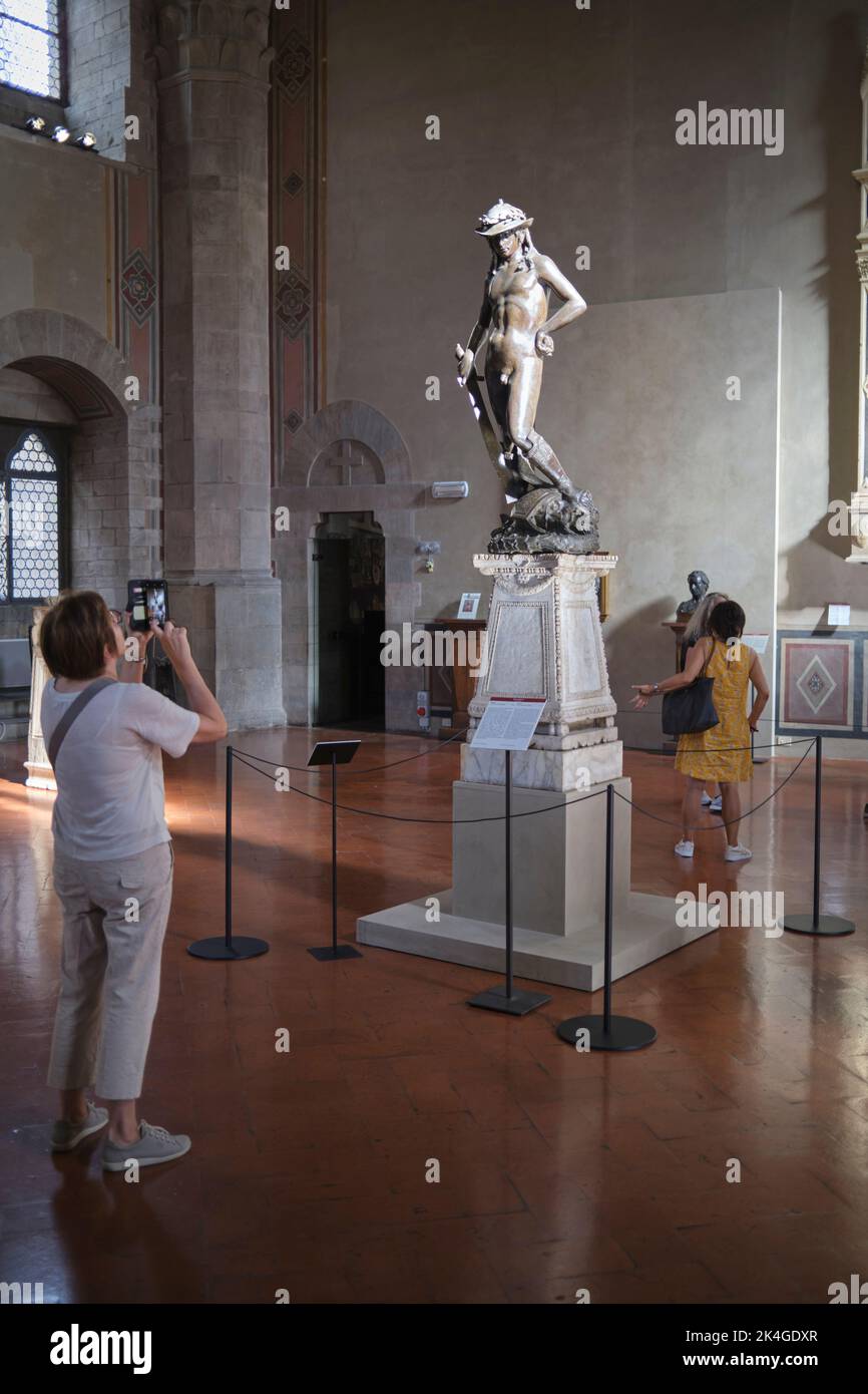 Visitor photographs the Statue of David by Donatello in the Bargello ...