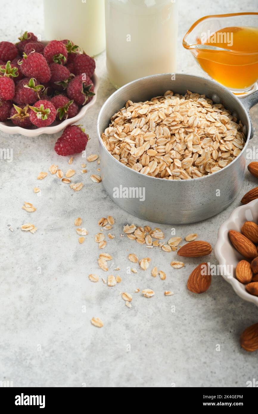 Ingredients for cooking oatmeal or granola with oats, milk, raspberries ...